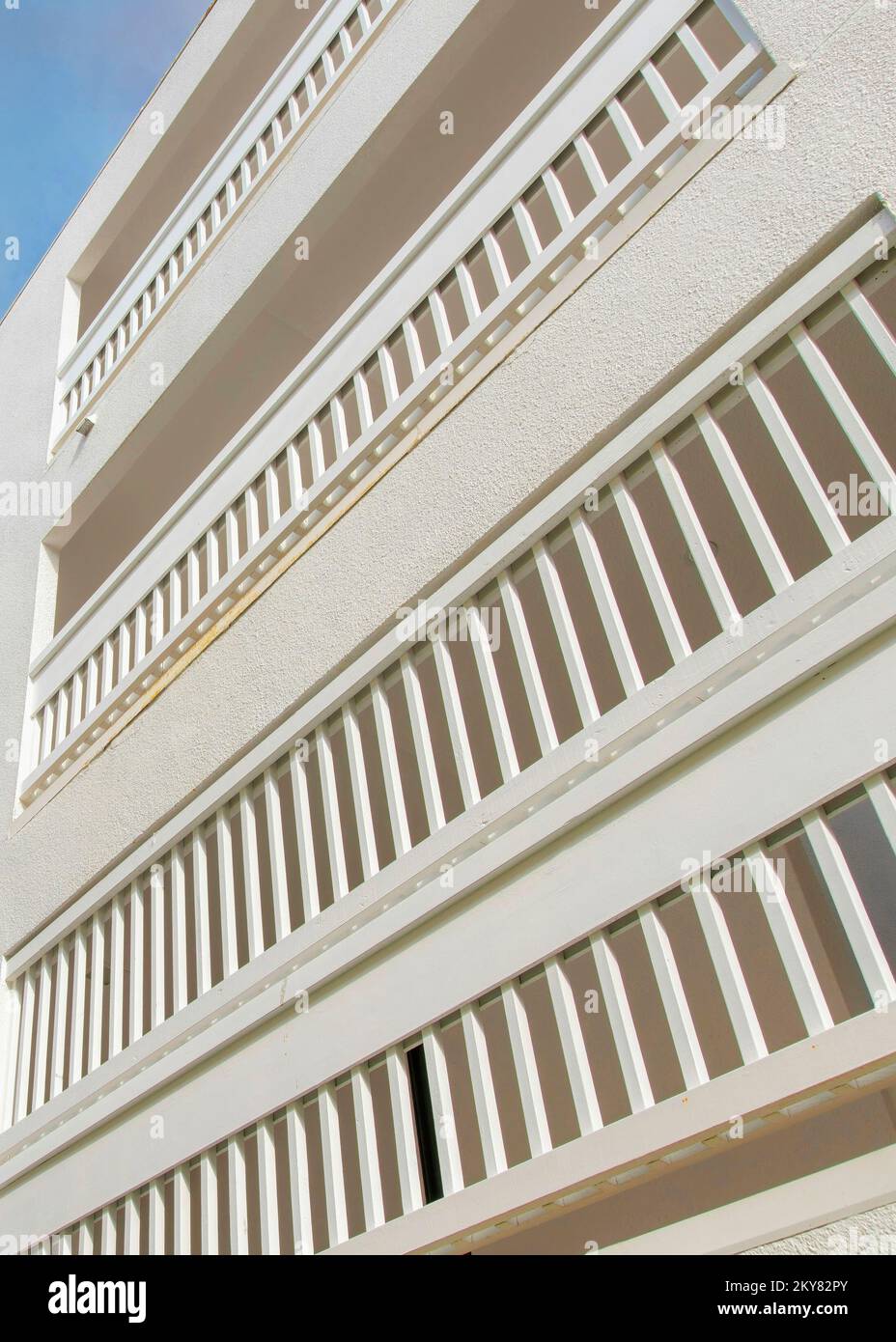 Vertical Puffy clouds at sunset Low angle view of a white building at ...