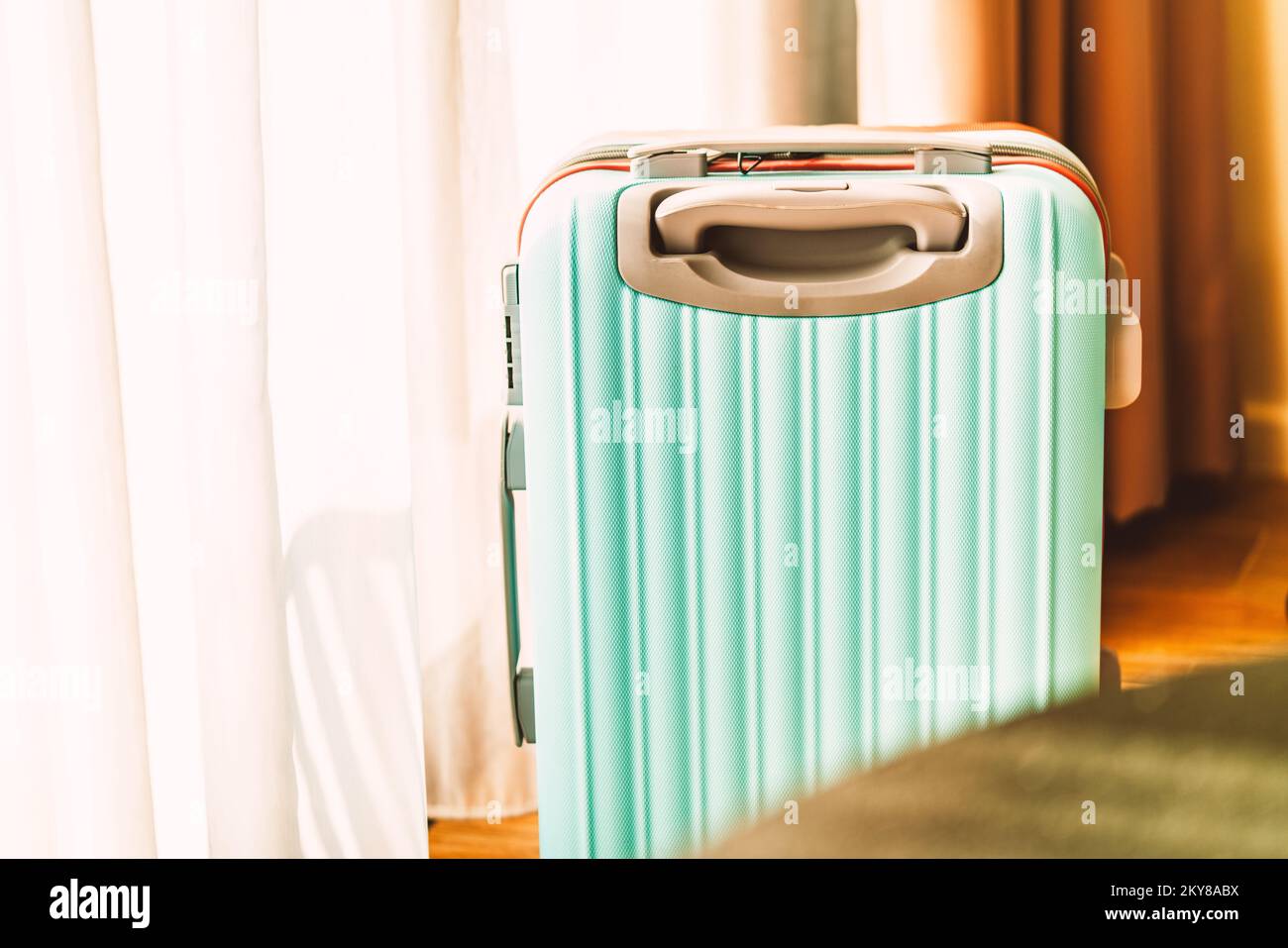 Small modern luggage with two-tone color, front view, stand on the ...