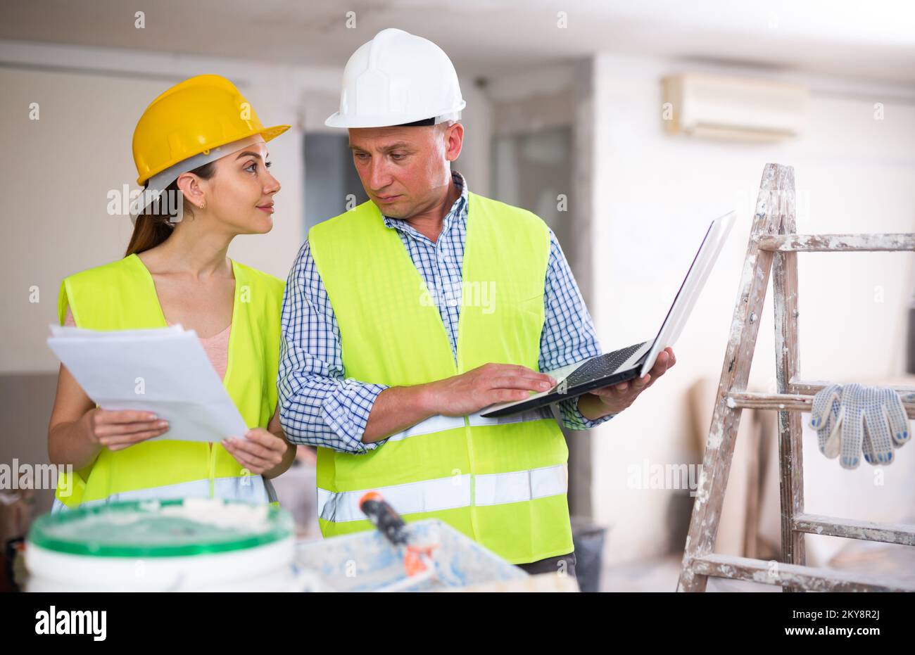 Construction workers working at house being renovated Stock Photo - Alamy