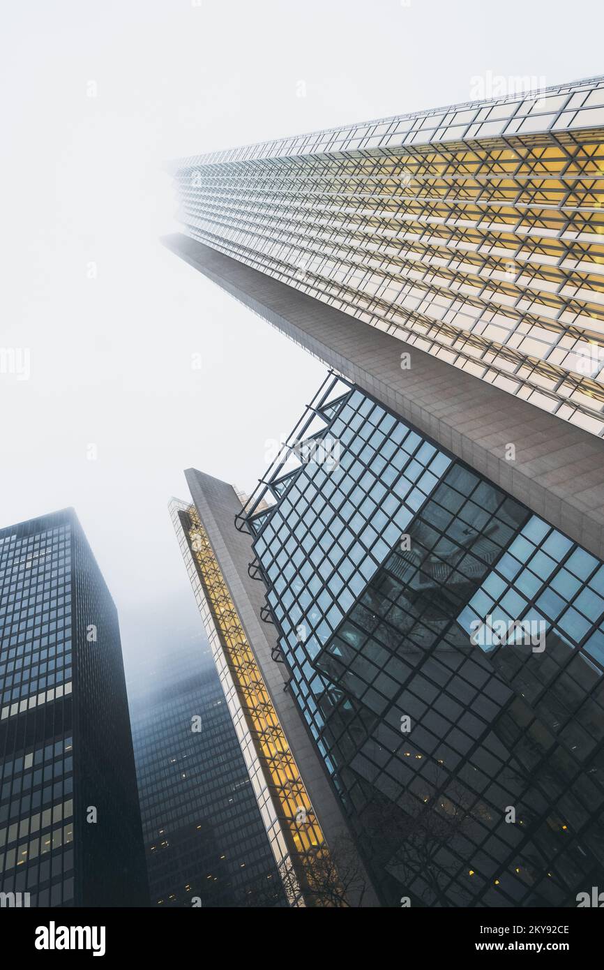 Modern office buildings reach up into low hanging cloud Stock Photo - Alamy