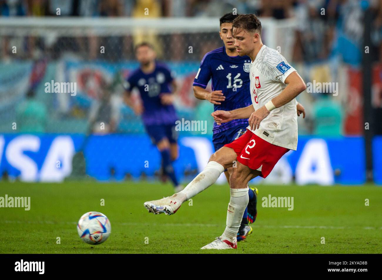 Matty Cash of Poland and Thiago Almada of Argentina during the FIFA ...
