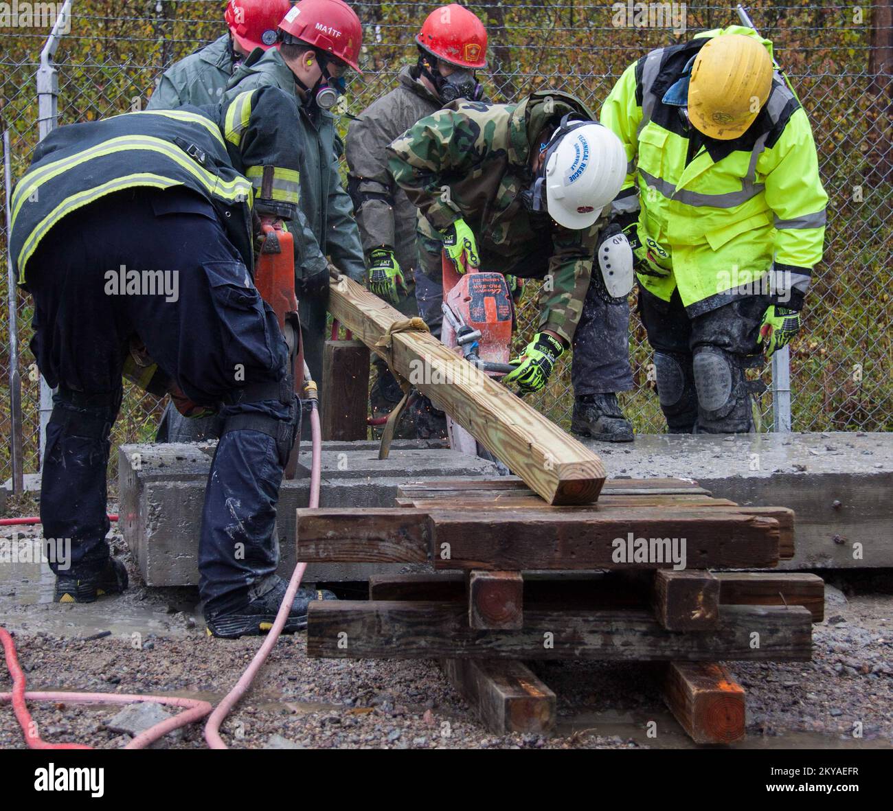 MA-TF1 team members cut through concrete with a K-12 rescue saw during ...