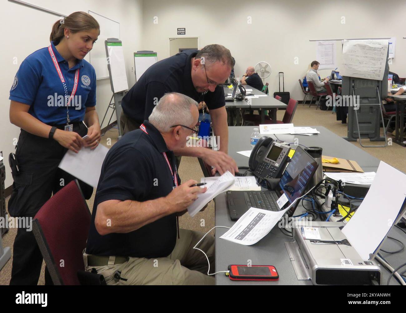 National IMAT West Team Lead Roger Laferriere (center) speaks with IMAT ...