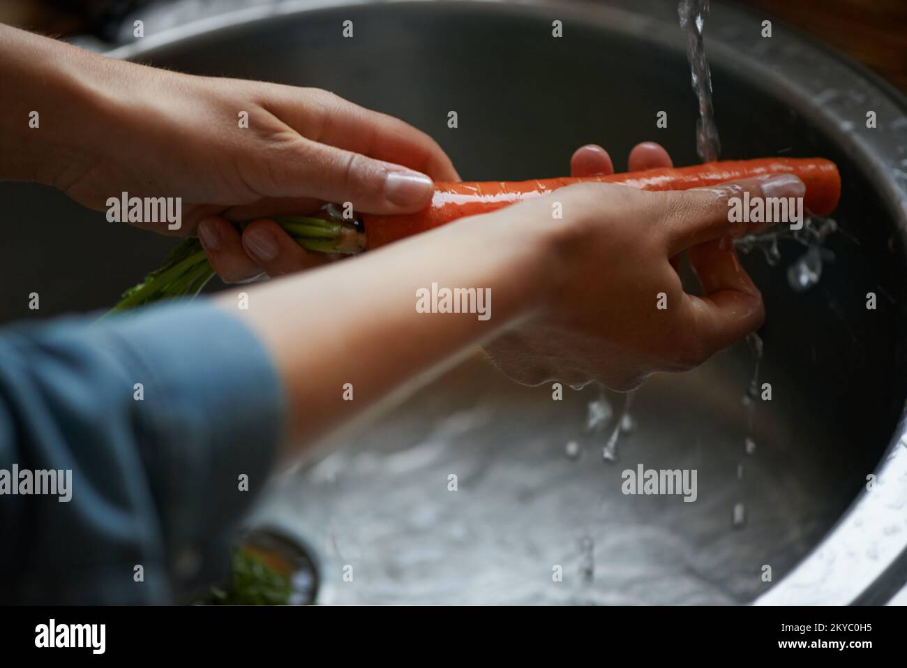 Washing them off before its time to cook. a woman washing vegetables in ...