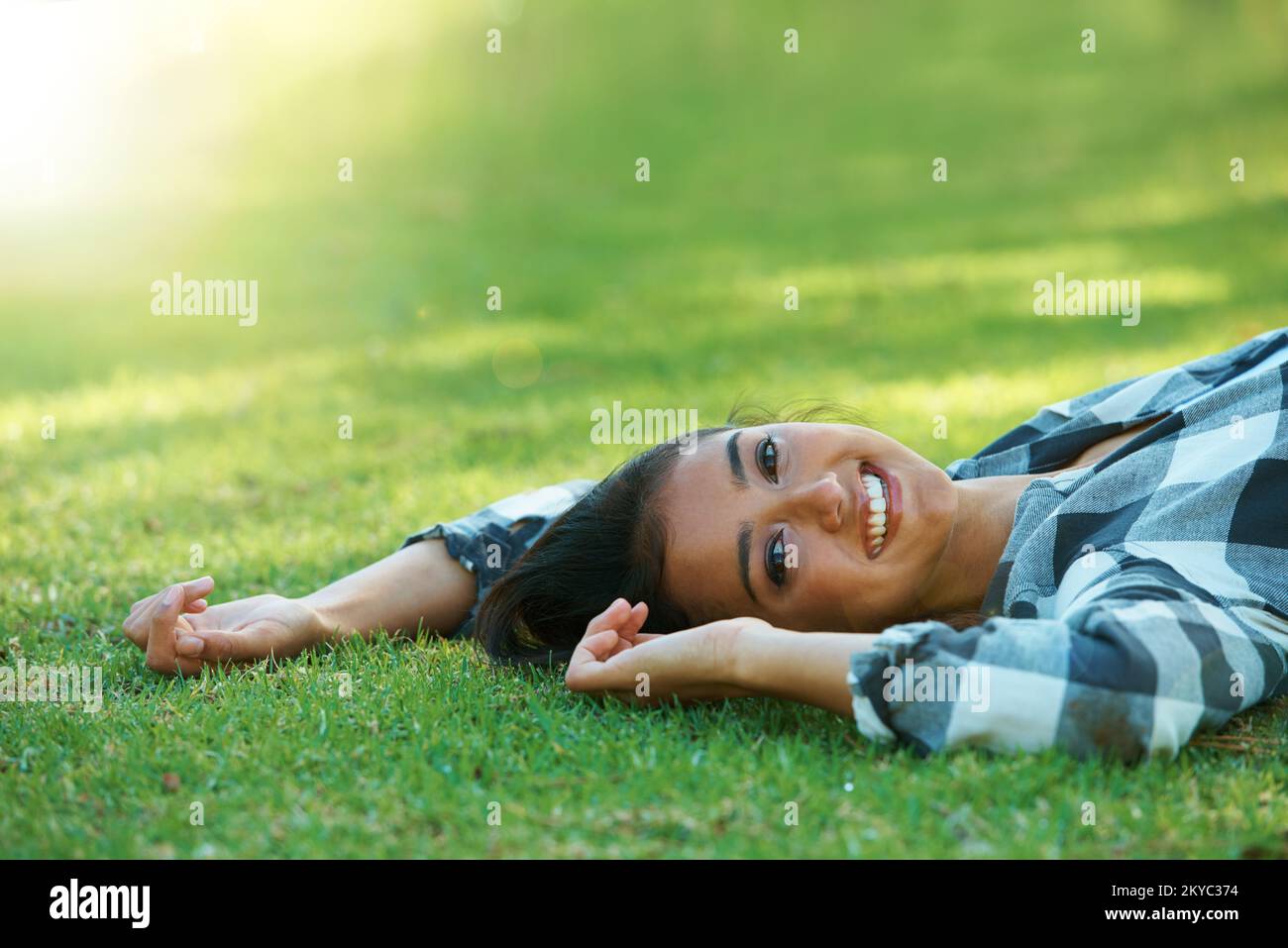 Her relaxing day in the park. Young woman relaxing in the park Stock ...