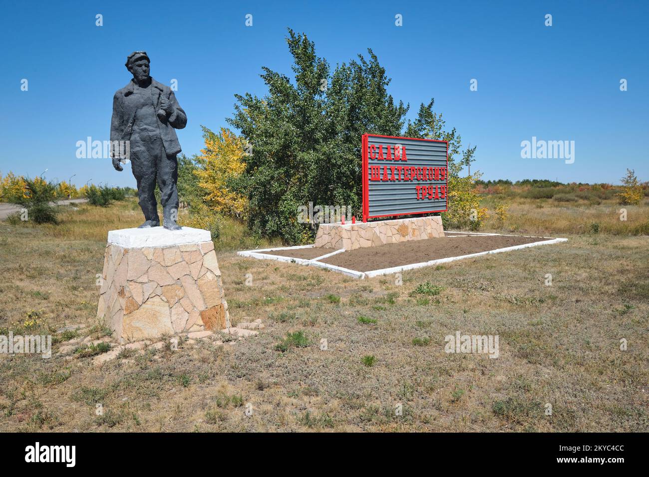 A black painted concrete statue of a generic, typical Soviet era coal ...