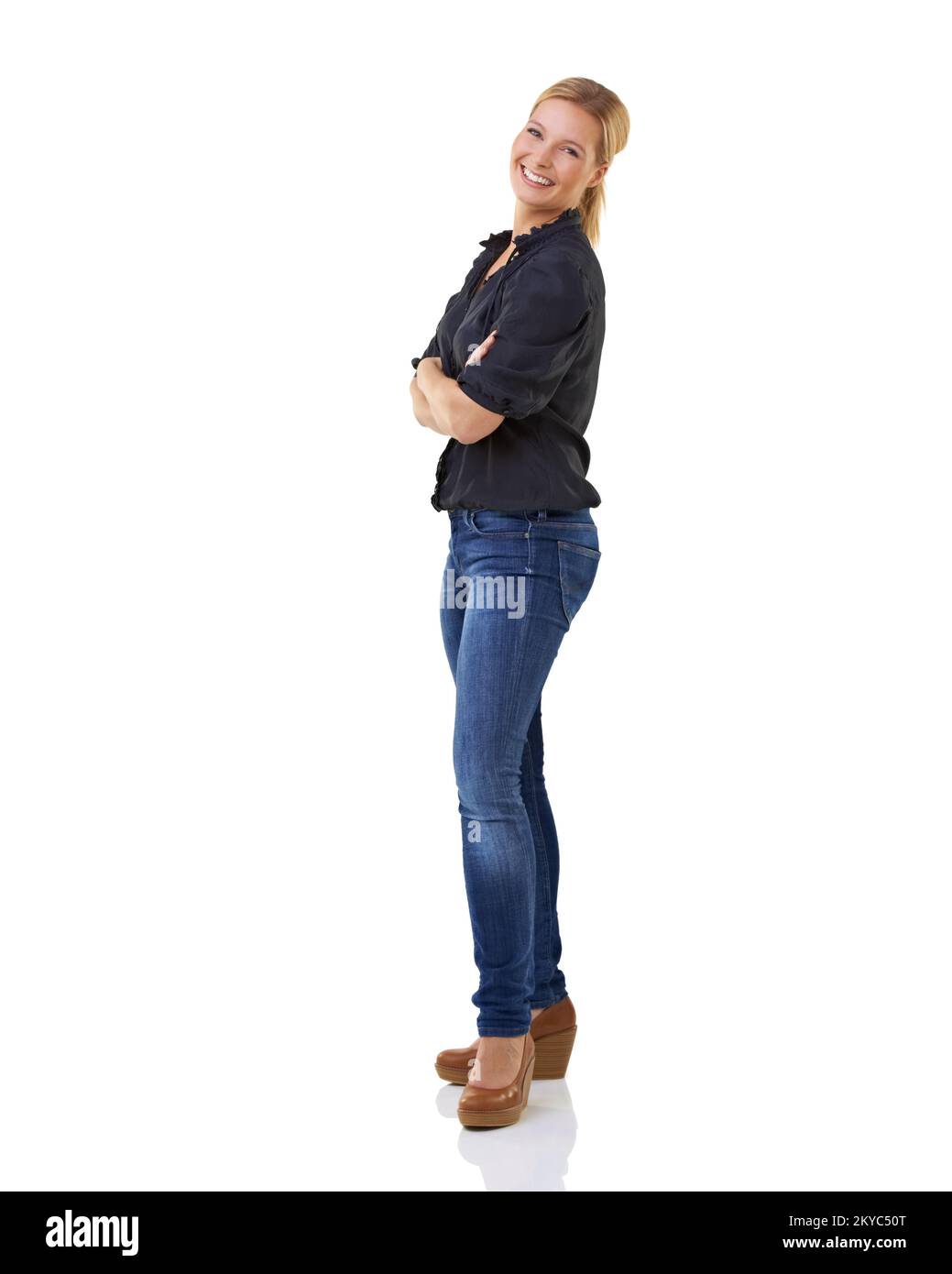 Confident pose. Full length studio shot of a young woman with her arms ...