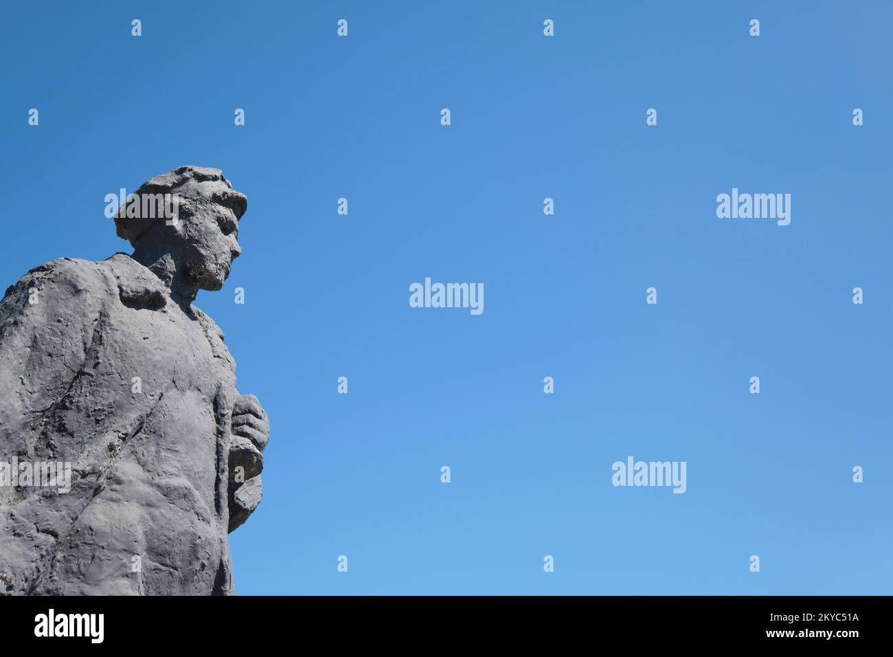 A black painted concrete statue of a generic, typical Soviet era coal ...