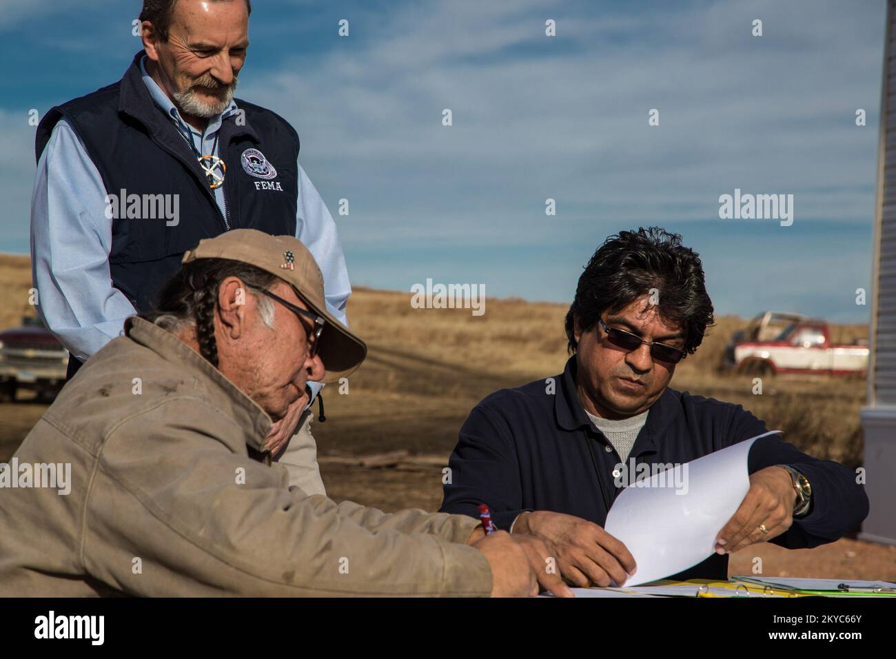 FEMA Federal Coordinating Officer Gary Stanley (background, left) and ...