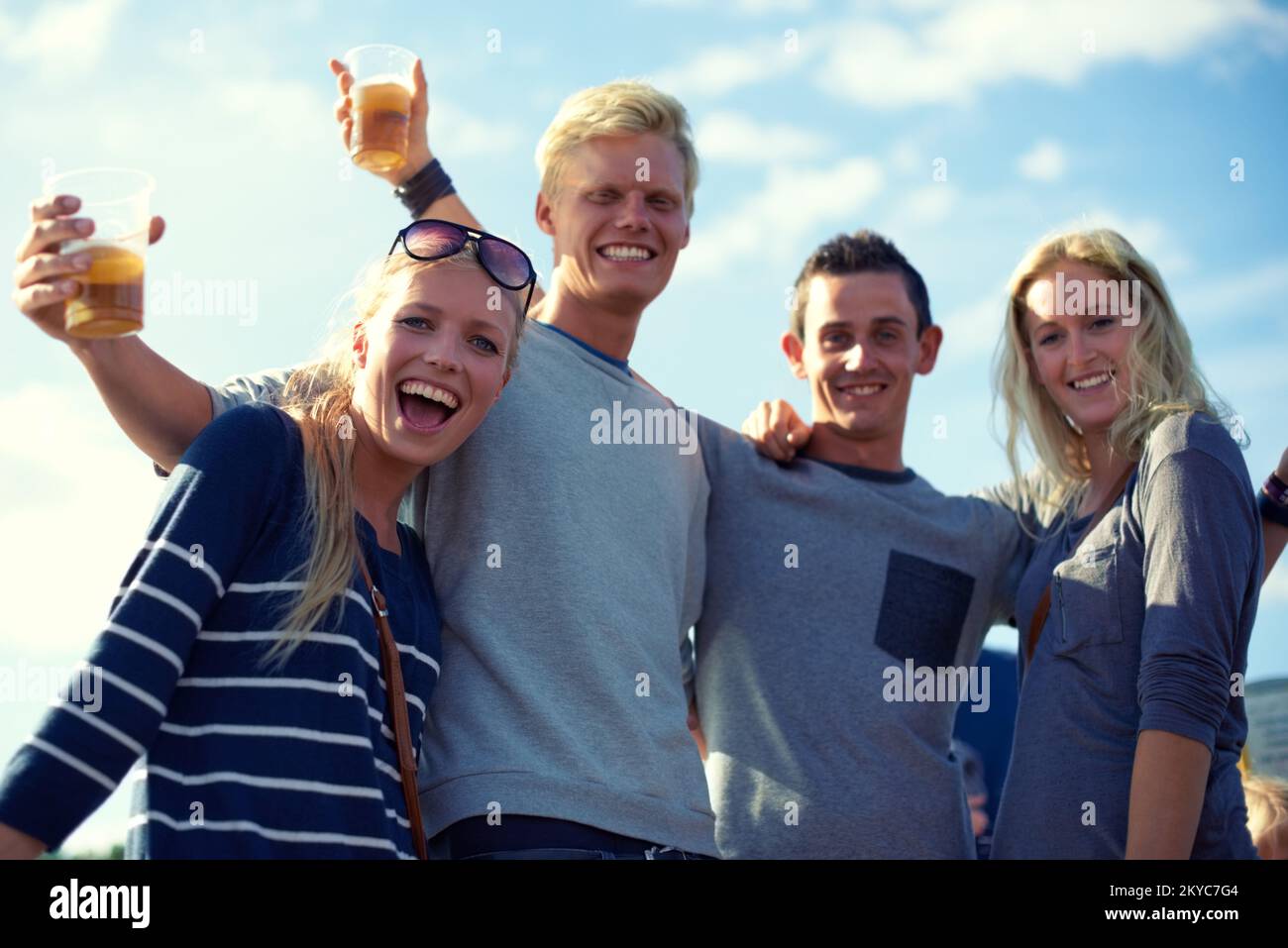 Cheers to life. Portrait of a group of young friends drinking beer ...