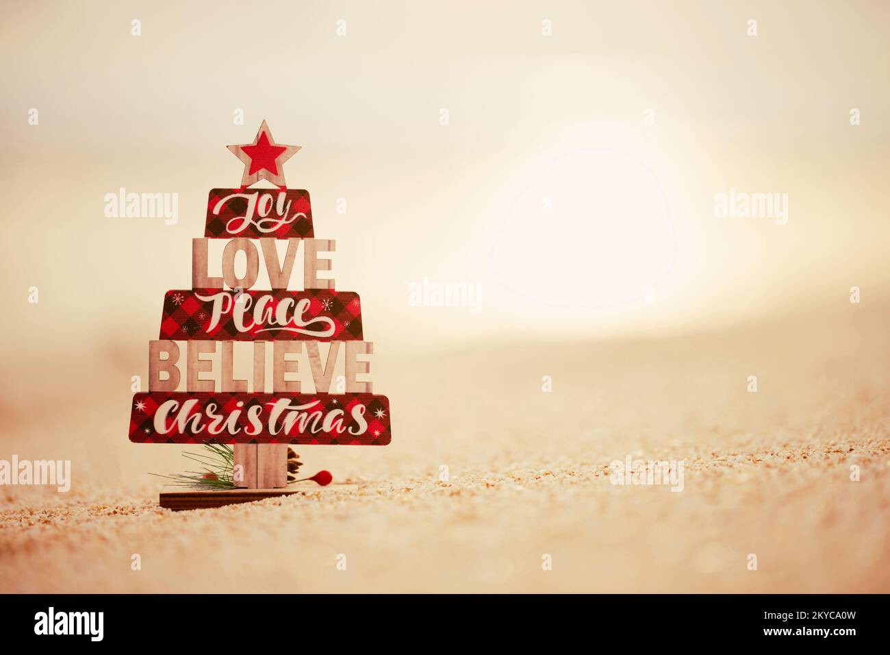 Wooden christmas tree toy on the beach Stock Photo - Alamy