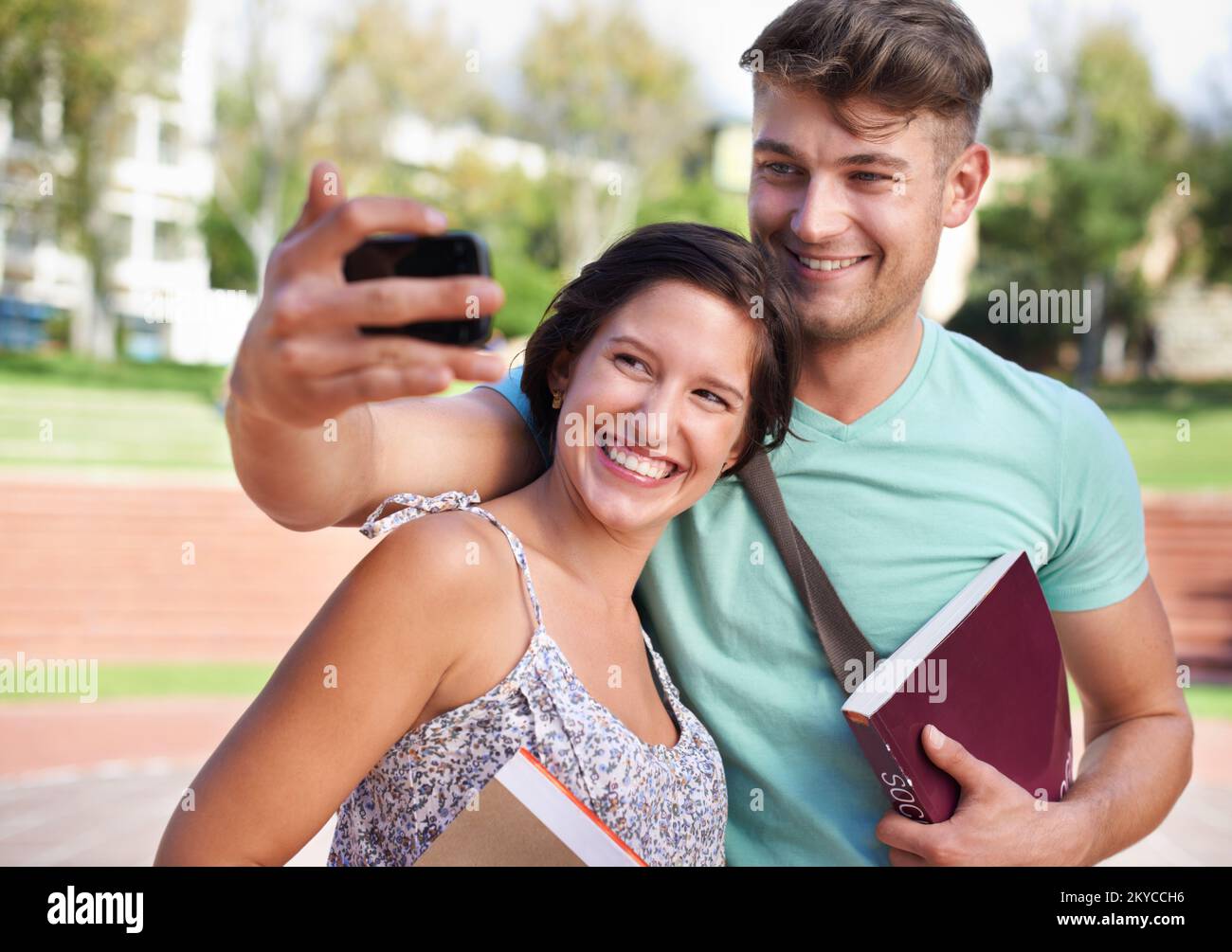 One for the year book. young college students taking a self-portrait on ...