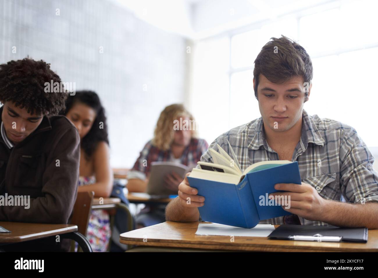 Trying to make get the highest grade. young college student studying ...