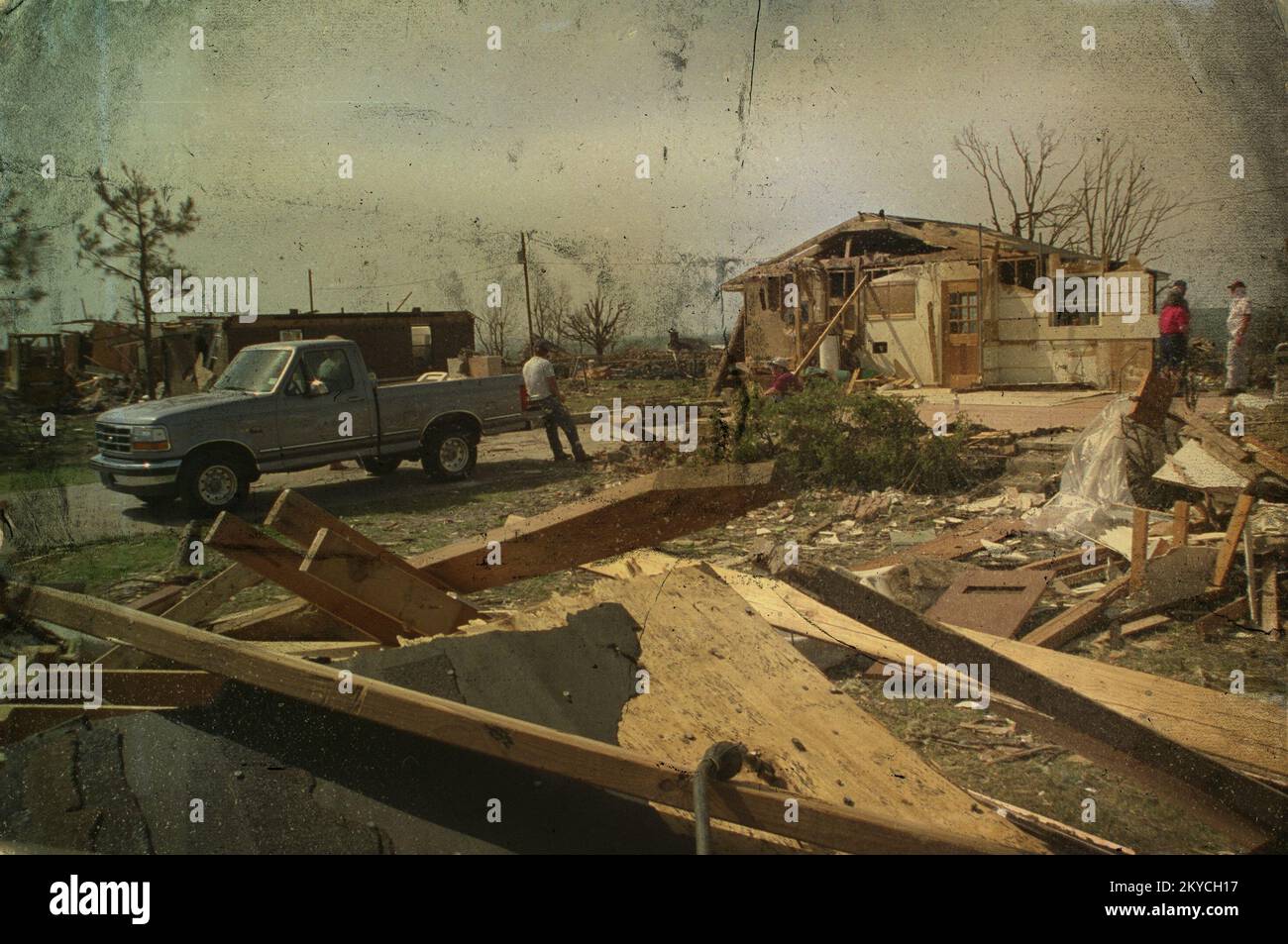 People survey damaged homes in Dade County, Florida, on August 24, 1992 ...