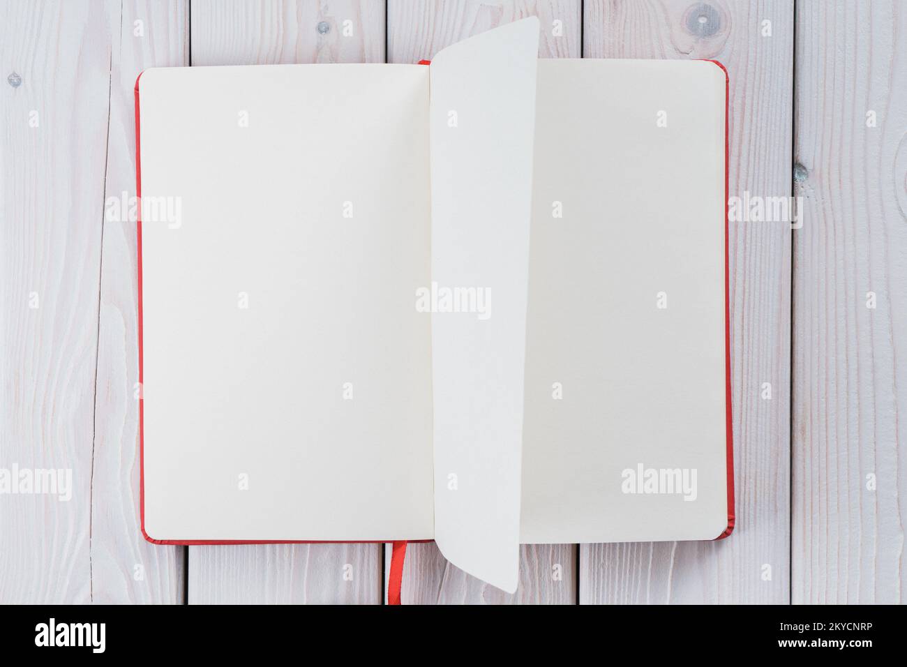 Red diary book with white empty papers, turn from right to left on ...
