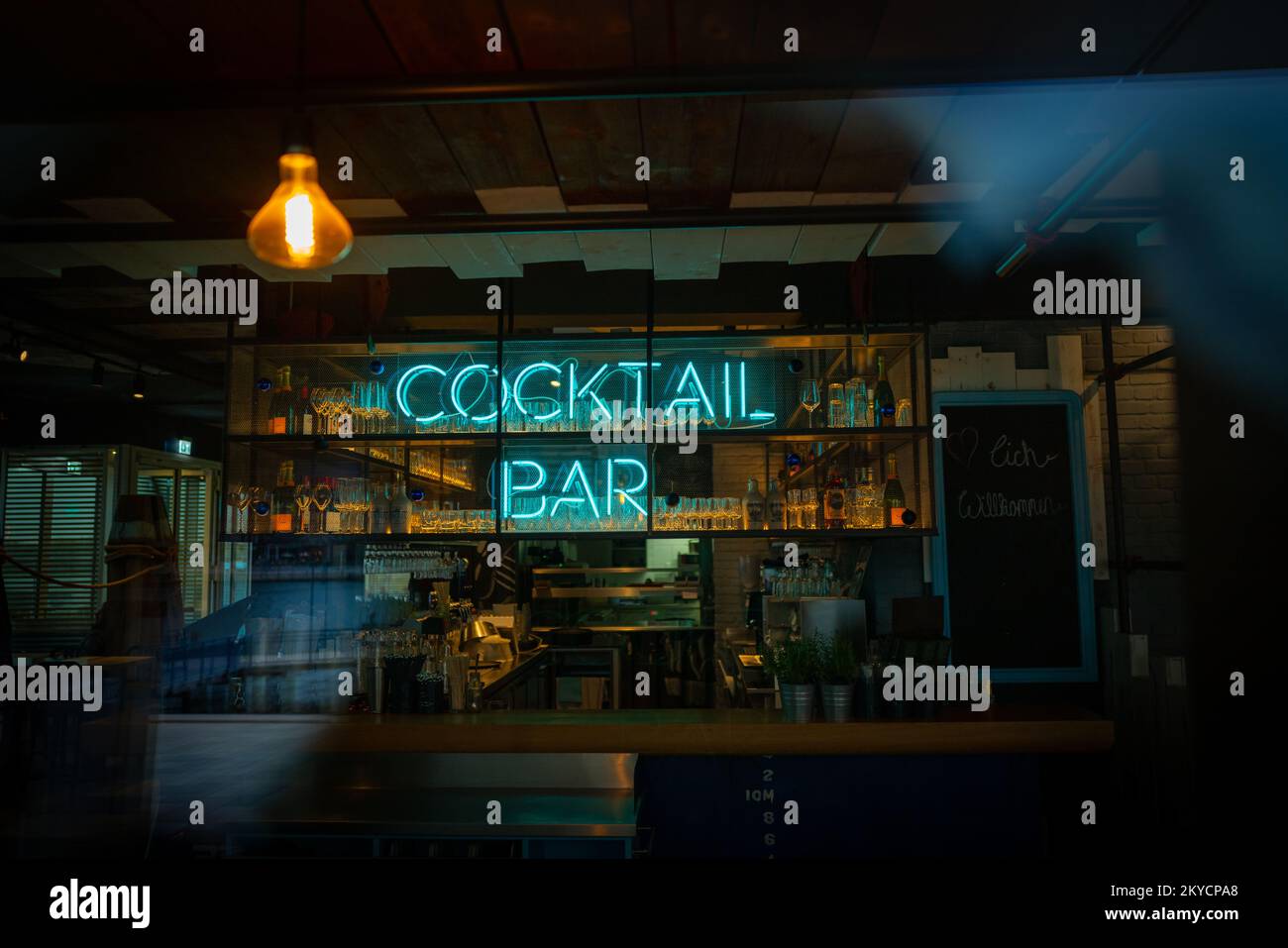 above the bar is written in illuminated letters cocktail bar Stock ...