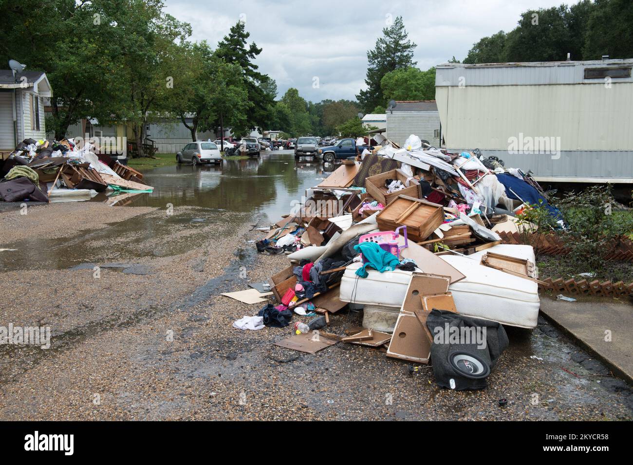 Piles of debris line the side of the roads in flood affected areas one ...