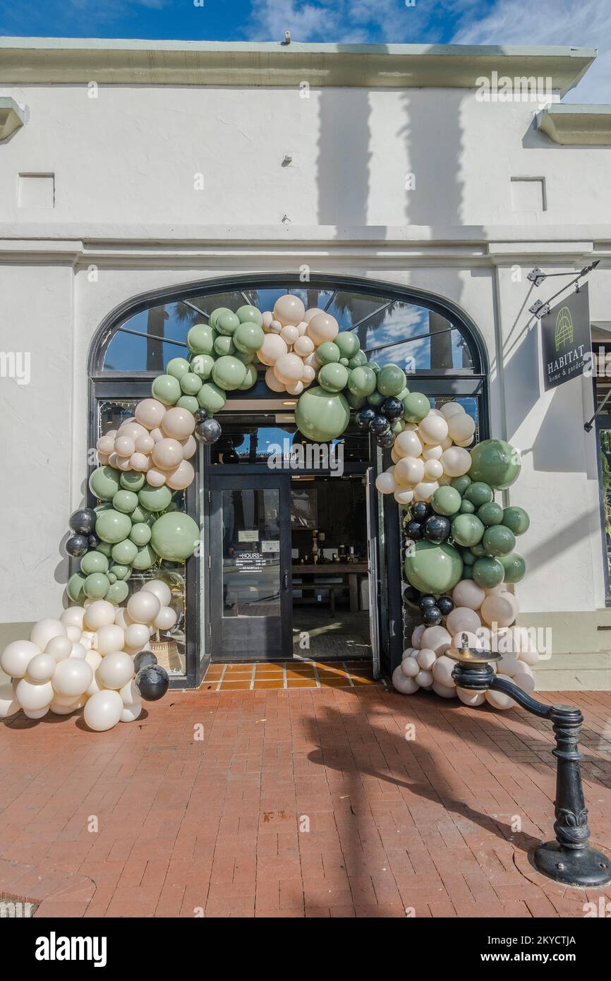 A stucco retail store decorated with an archway of many sizes of ...