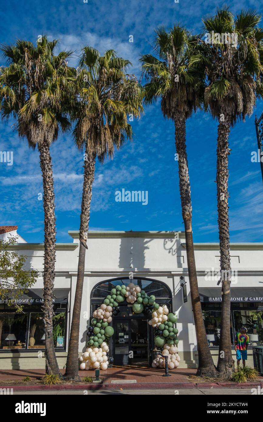 A stucco retail store decorated with an archway of many sizes of ...