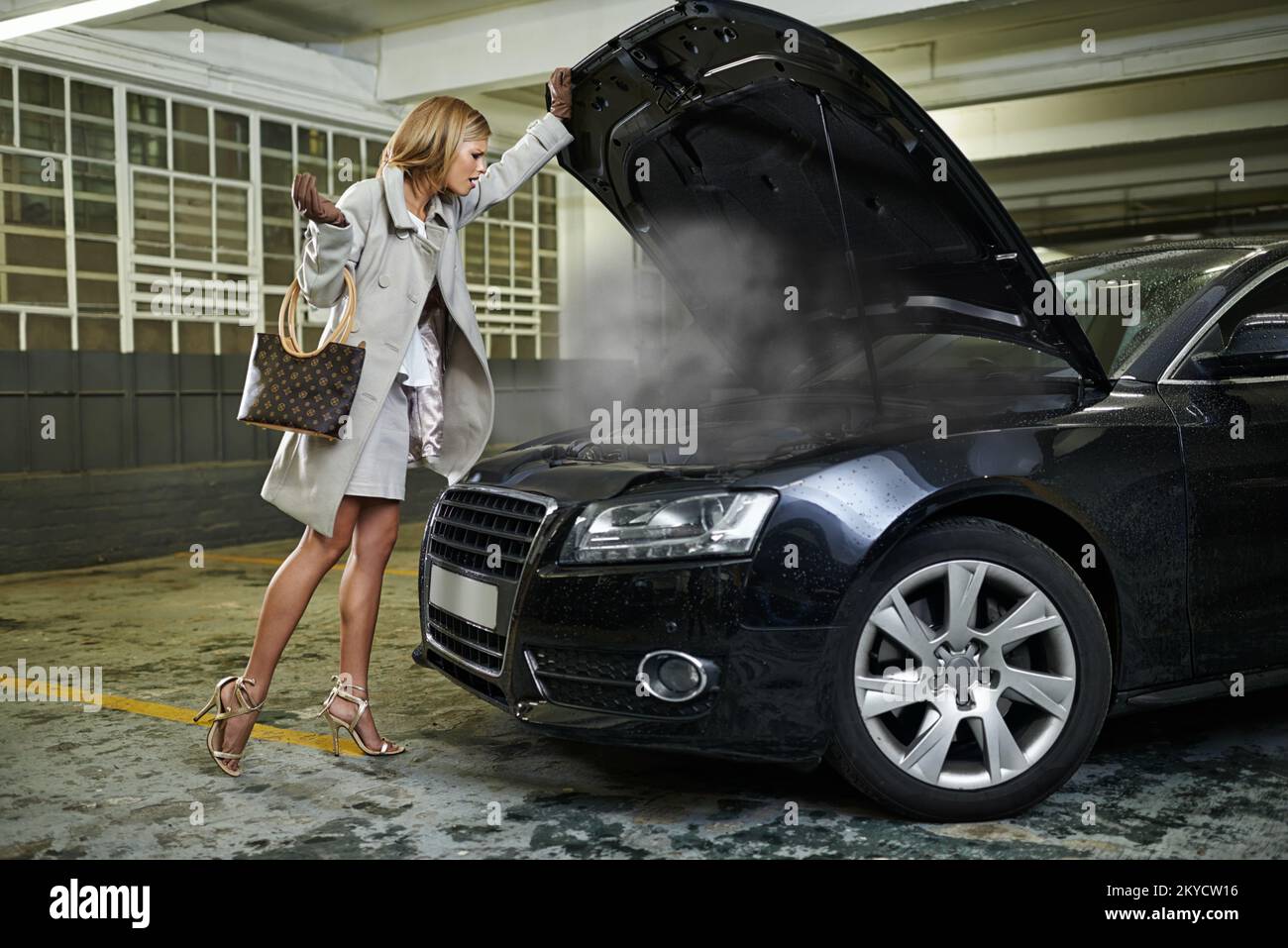 Her car is busted. Full length of a young woman standing alongside her ...