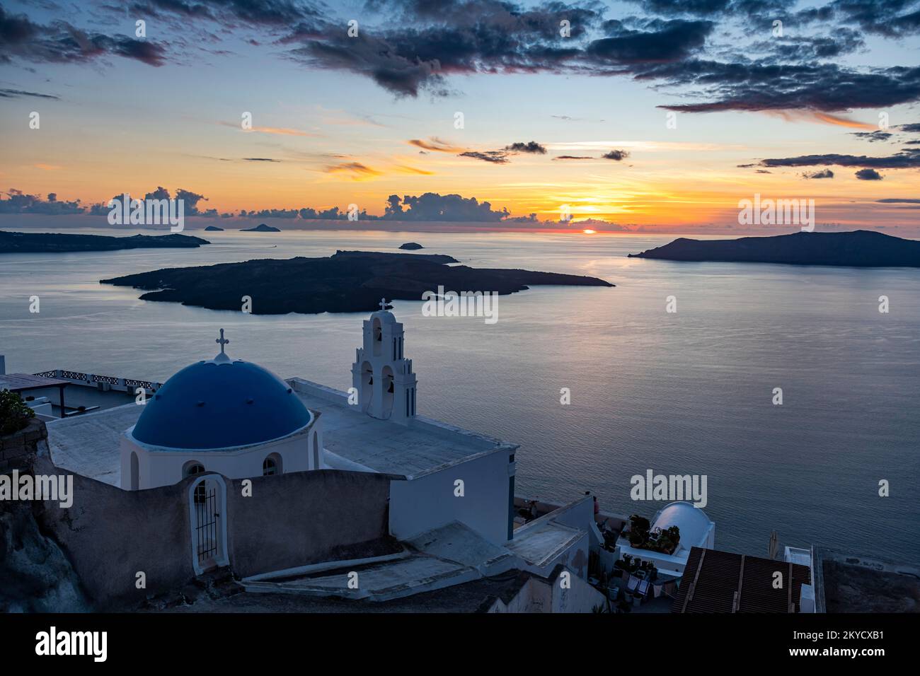 Sunset over the volcanic islands of Santorini and Anastasi Orthodox ...