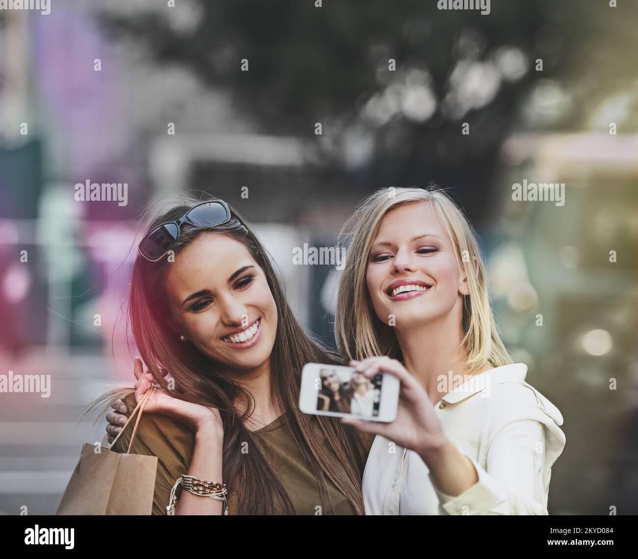 Shopping spree selfie. two young women taking a selfie while out shopping in the city Stock ...