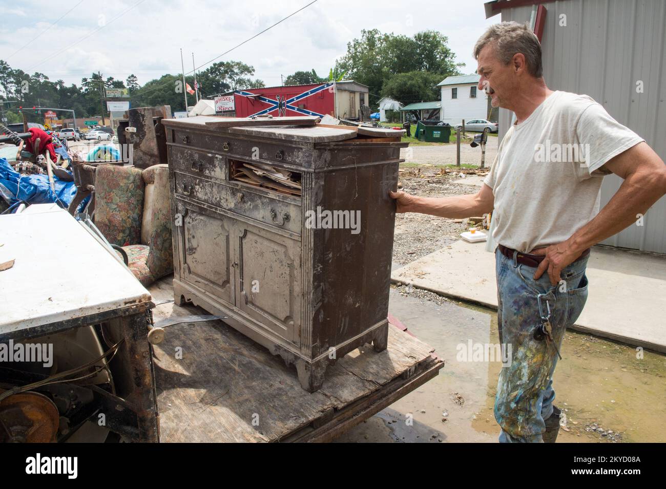Rodney Lewis stands by the few items he was able to recover from his ...