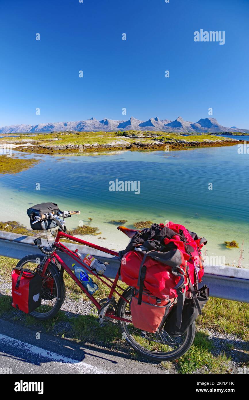 Packed touring bike, crystal clear water in a shallow bay, view of the ...