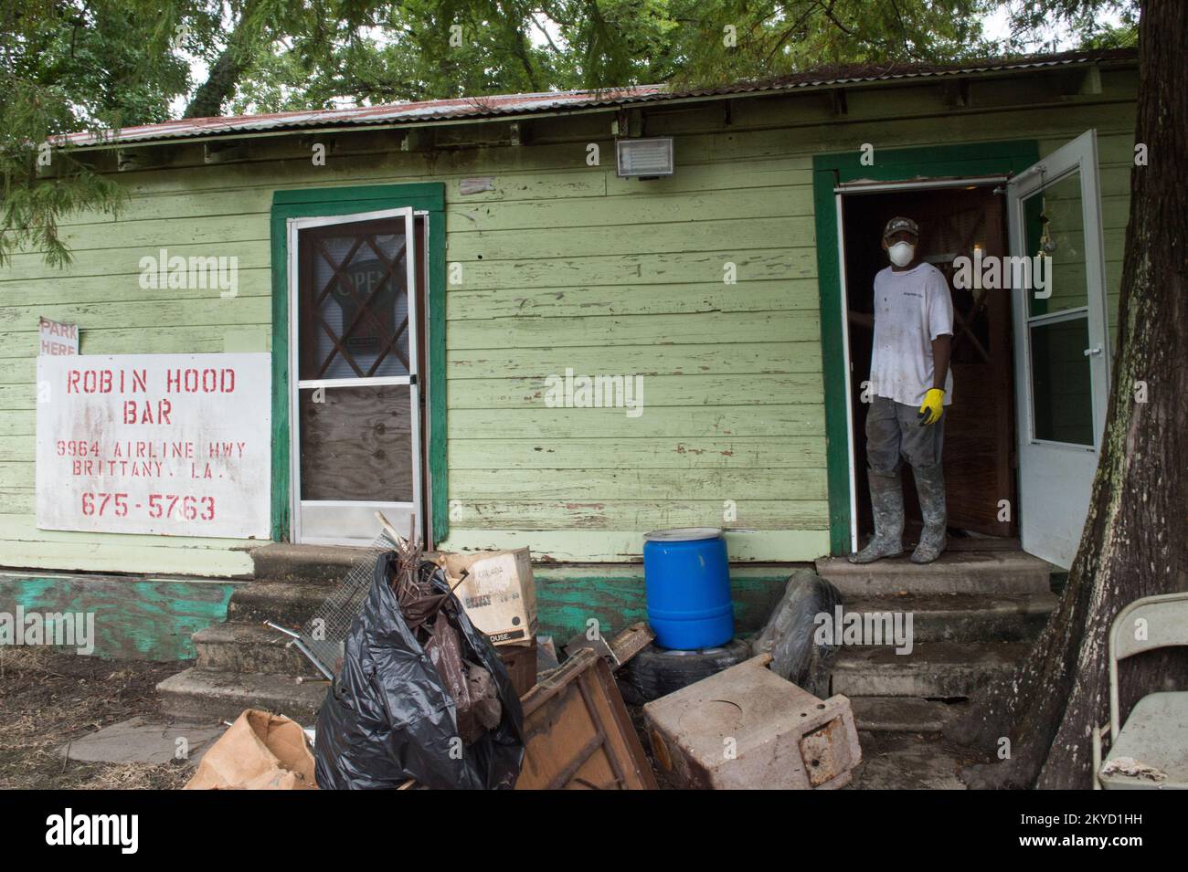 Kevin Mcquarn cleans out the flood debris from his family's business ...