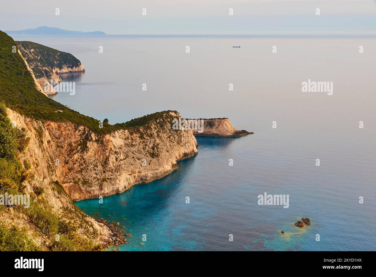 Lonely stretches of coast in the southwest, blue hazy sky, steep rocky ...