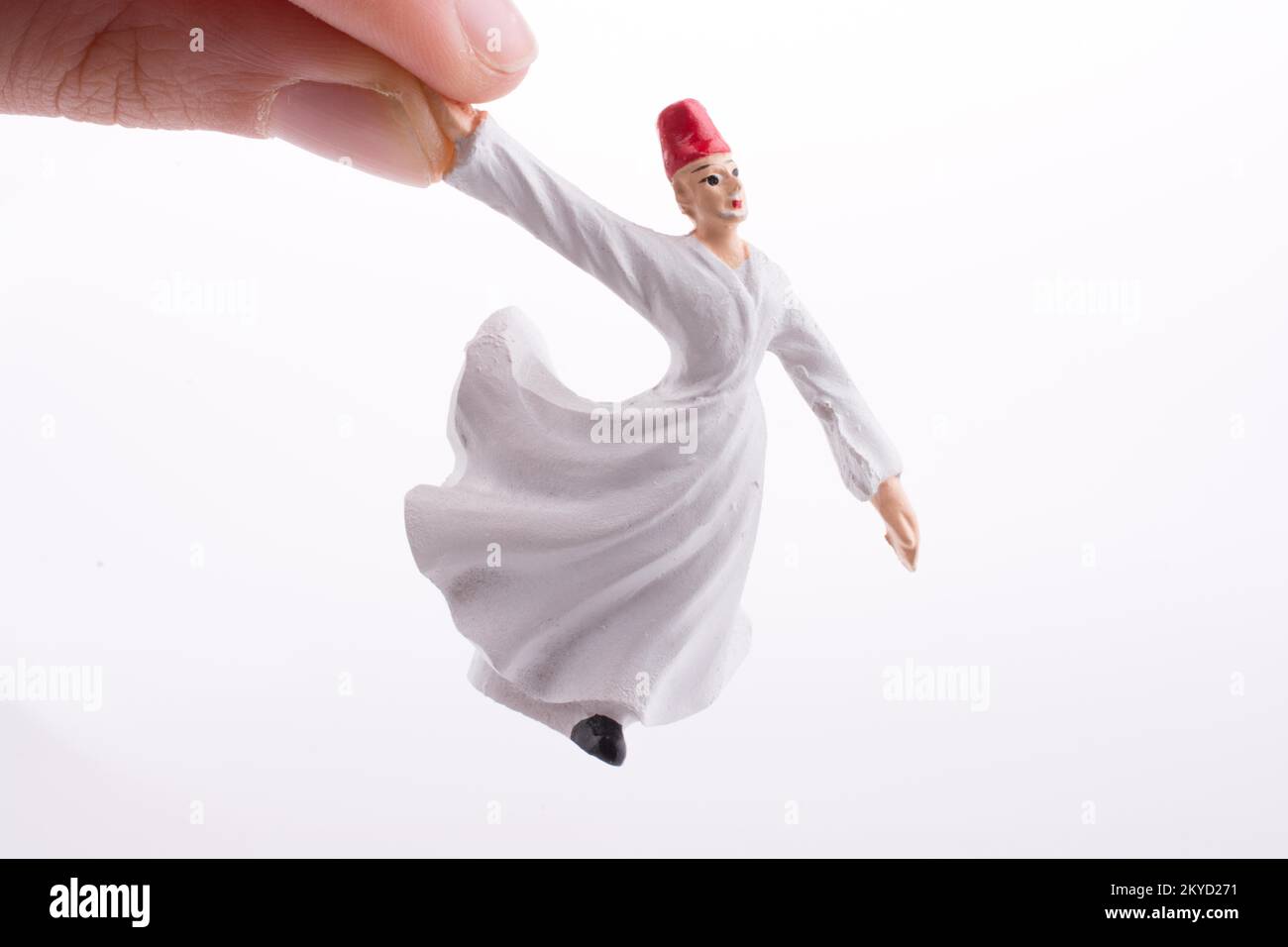 Hand holding a Sufi Dervis on a white background Stock Photo - Alamy
