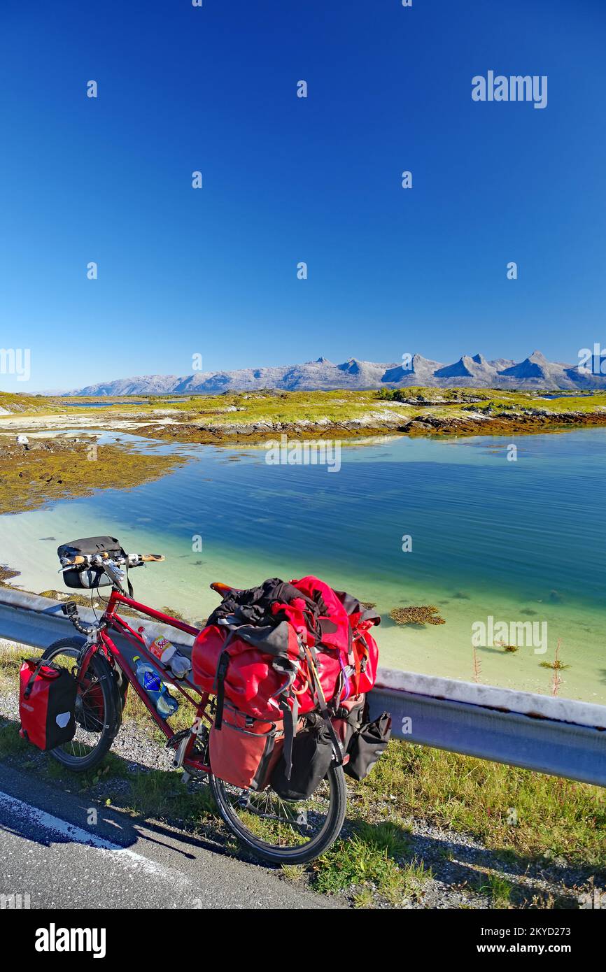 Packed touring bike, crystal clear water in a shallow bay, view of the ...