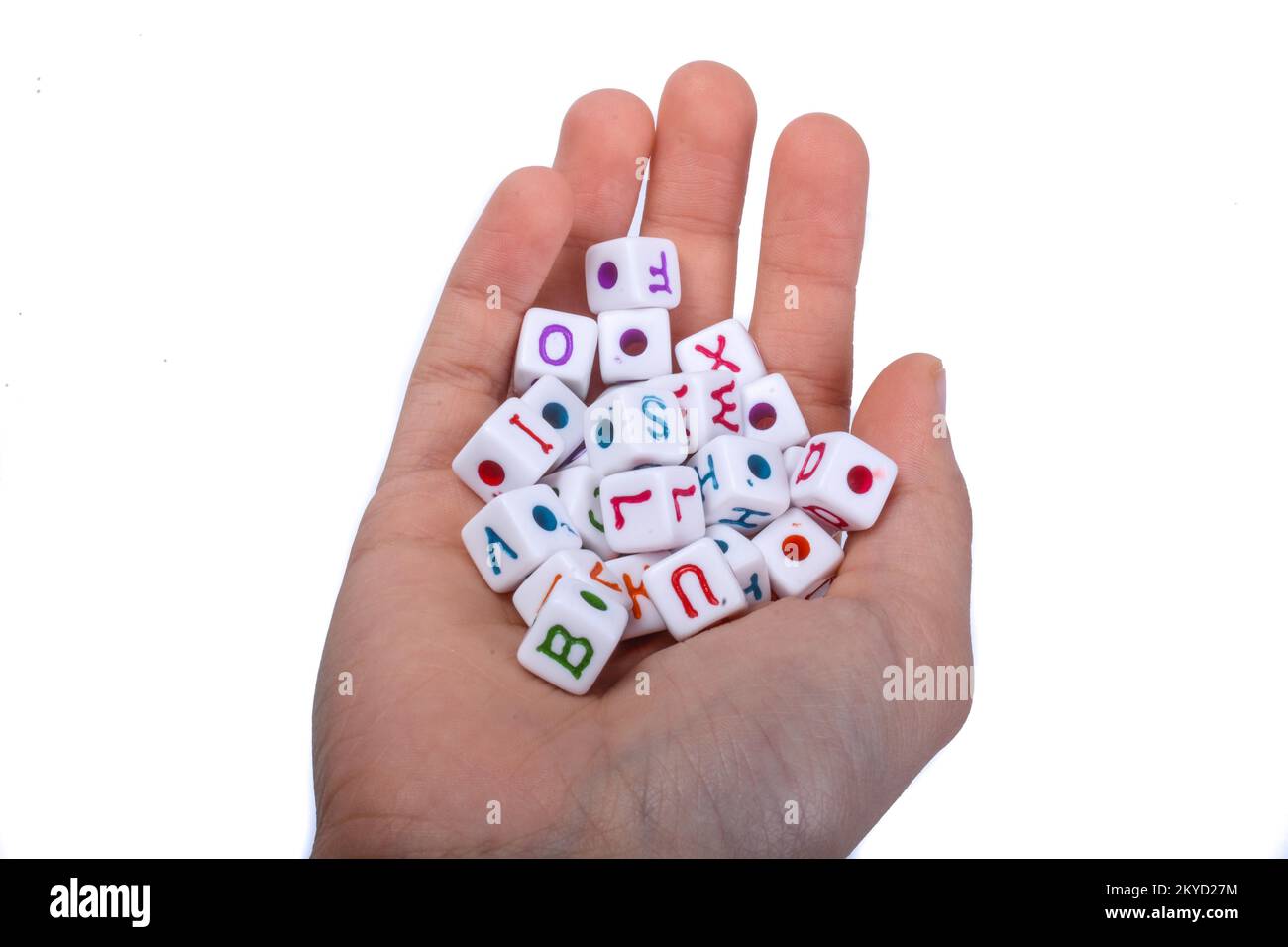 Hand holding colorful alphabet letters as cubes on white background ...