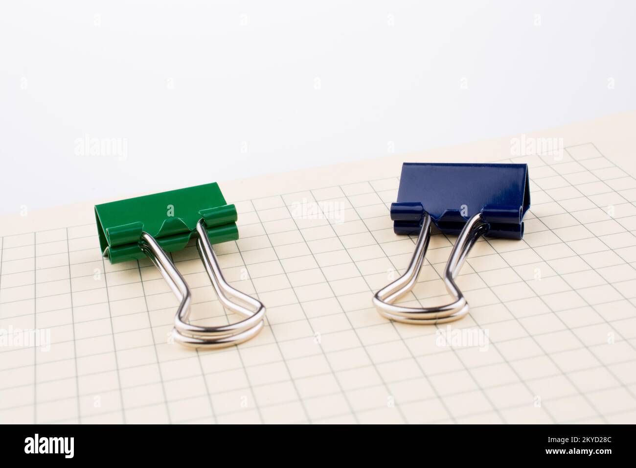 Colored paper clip on a checked notebook page Stock Photo - Alamy
