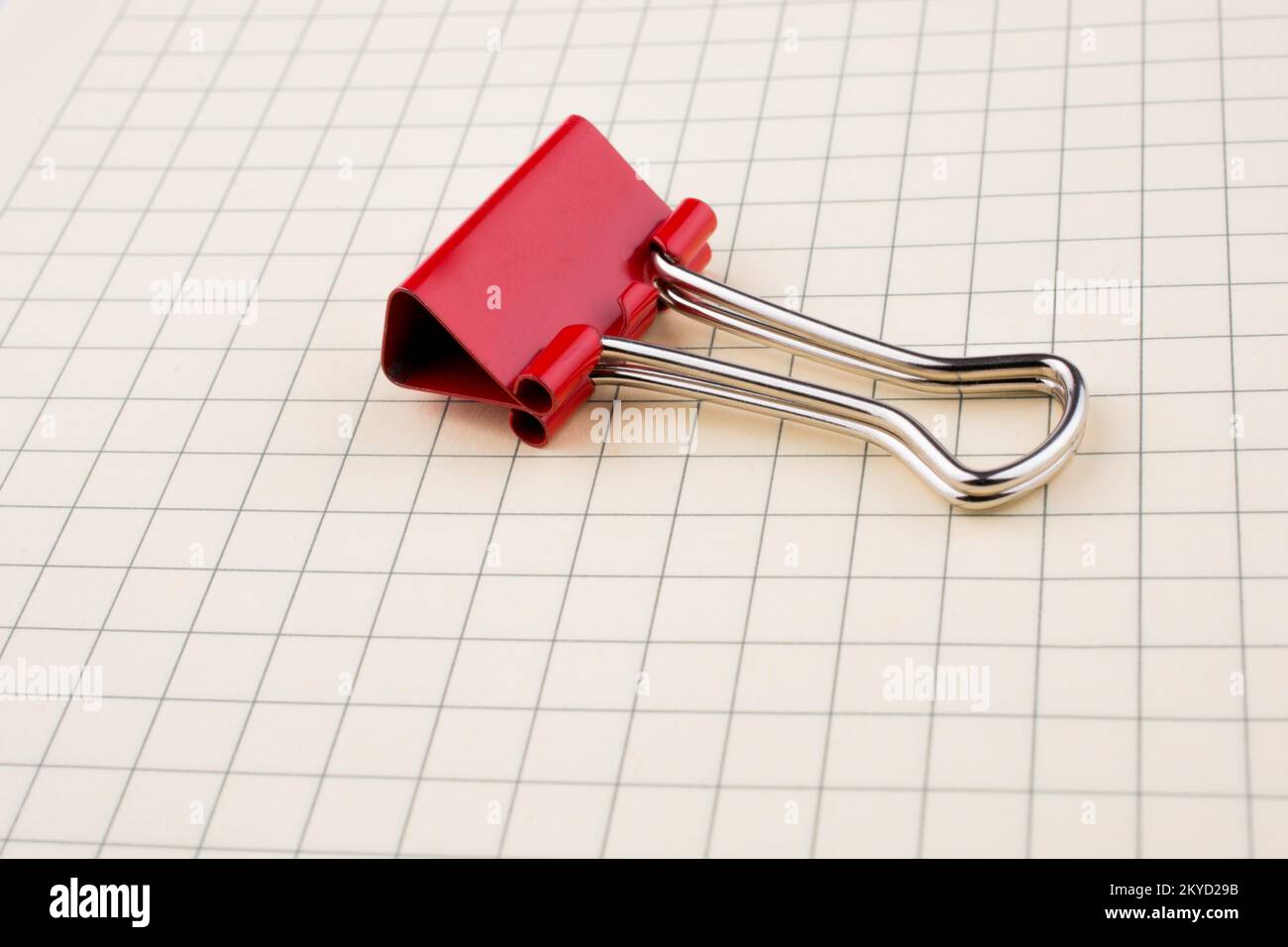 Colored paper clip on a checked notebook page Stock Photo - Alamy
