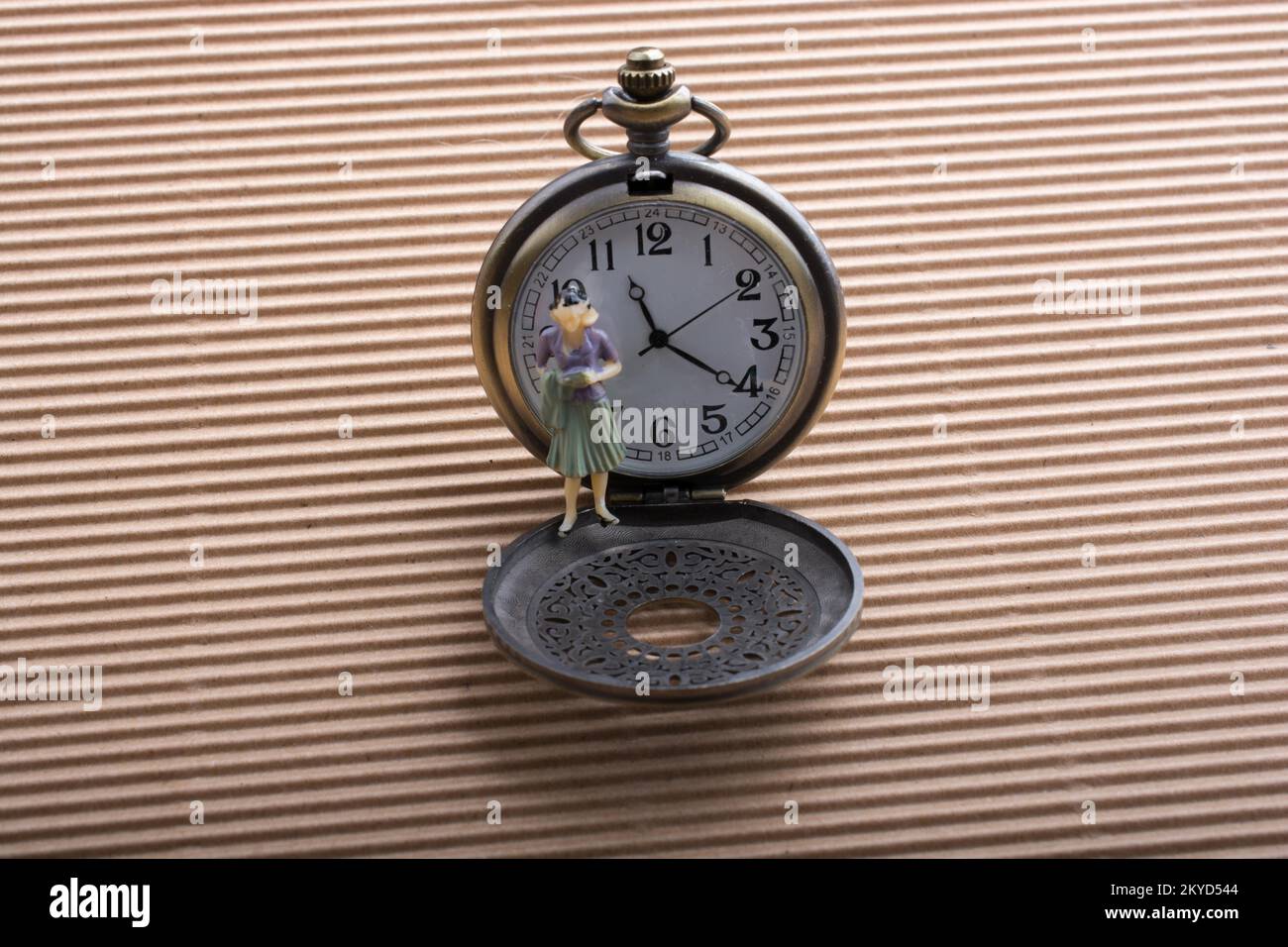 Paper woman shape and a retro pocket watch Stock Photo - Alamy