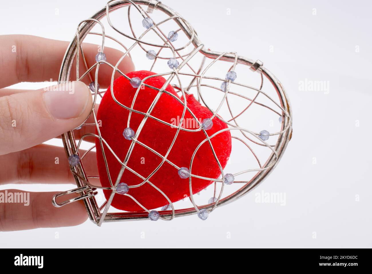 Red heart in a heart shaped cage Stock Photo - Alamy