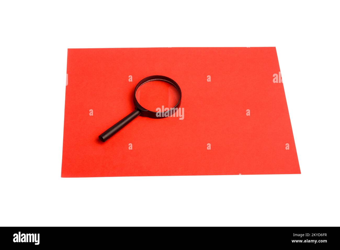 Magnifying glass on a sheet of paper on white background Stock Photo ...