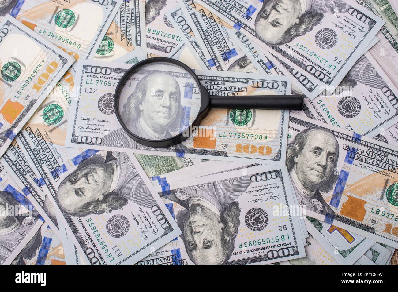 Magnifying glass is placed over of US dollar the banknotes Stock Photo ...