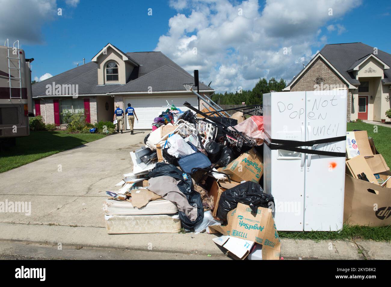 FEMA Corps members Nakiya Soloman (right) and Raven Rospierski approach ...