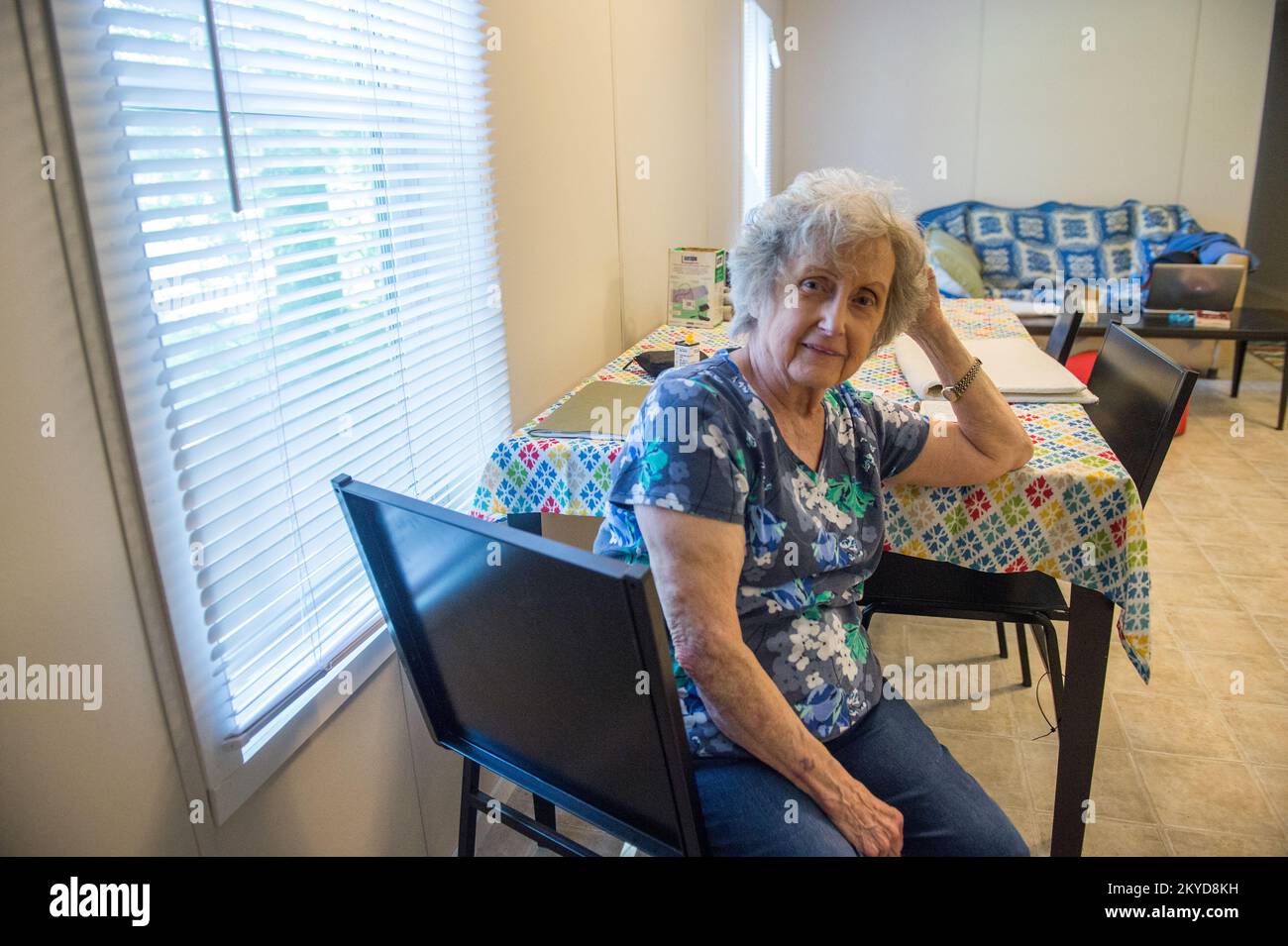 Flood survivor Mary Ann Wallace sits comfortably in the kitchen/dining ...