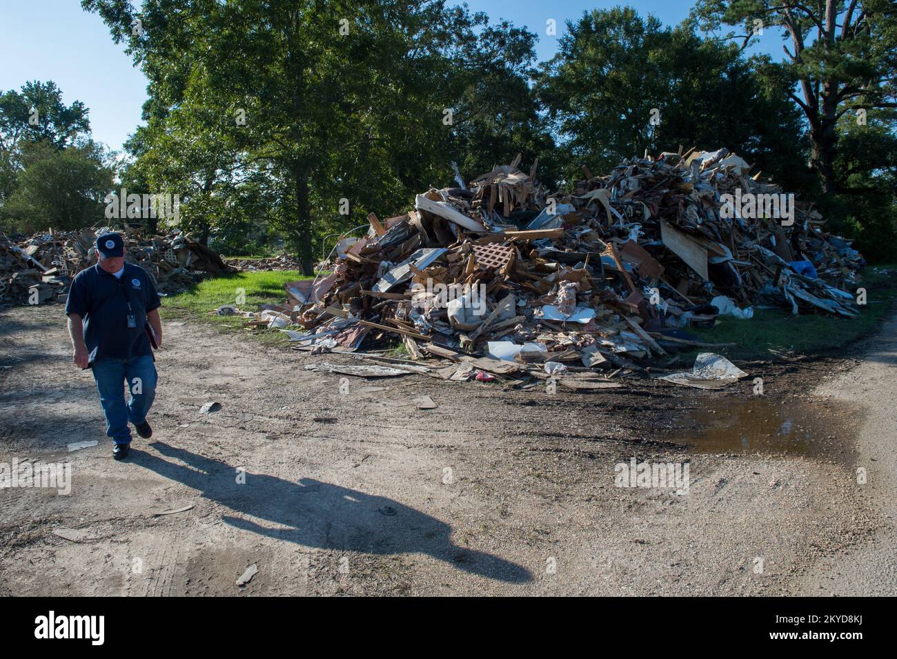 FEMA Disaster Survivor Assistance (DSA) team member Randy Collier walks ...