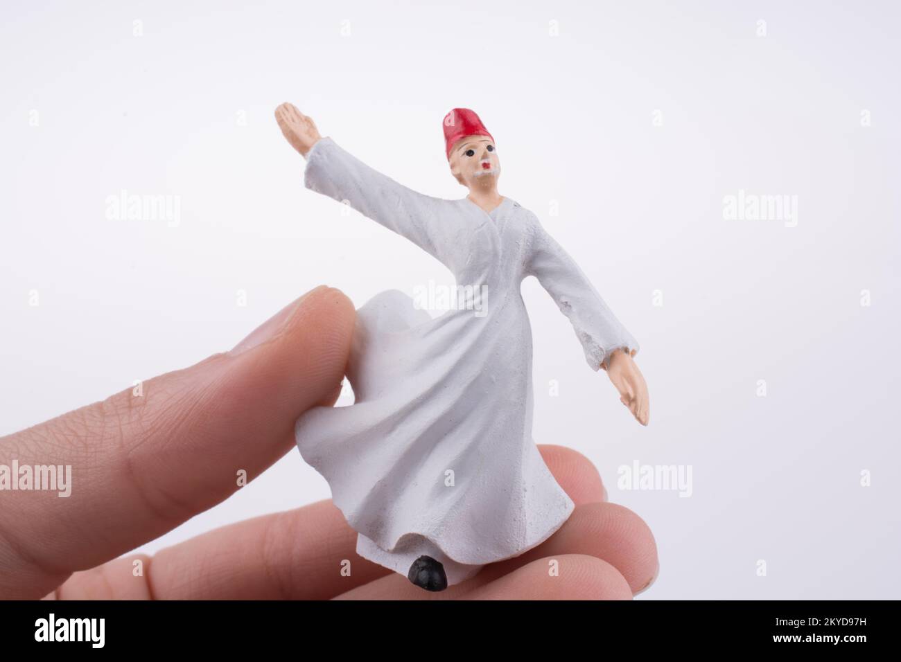 Hand holding a Sufi Dervis on a white background Stock Photo - Alamy