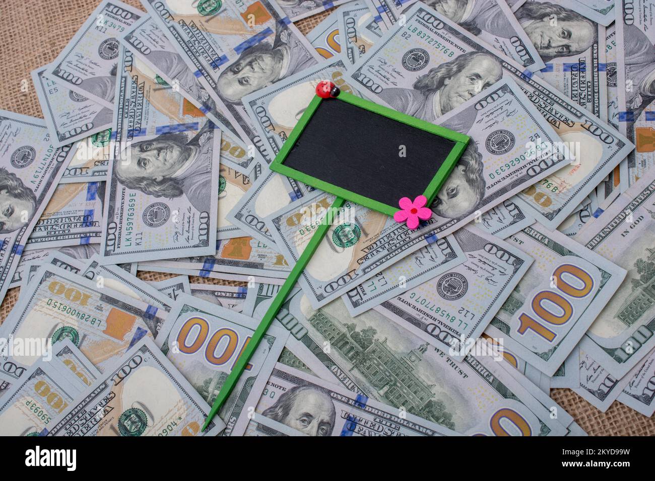 Notice board placed on spread US dollar banknotes Stock Photo - Alamy