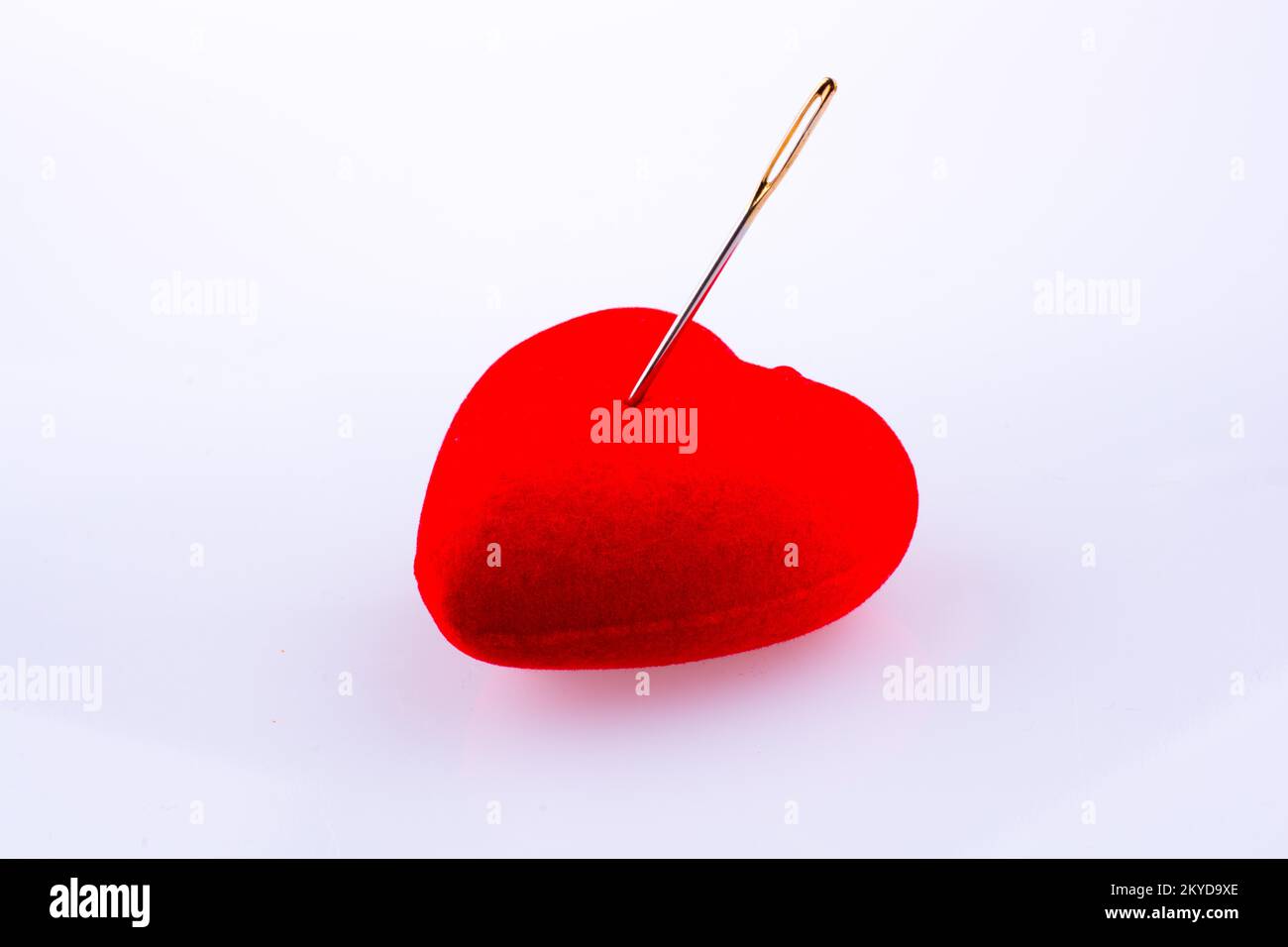 Hand pointing a needle on a heart Stock Photo - Alamy
