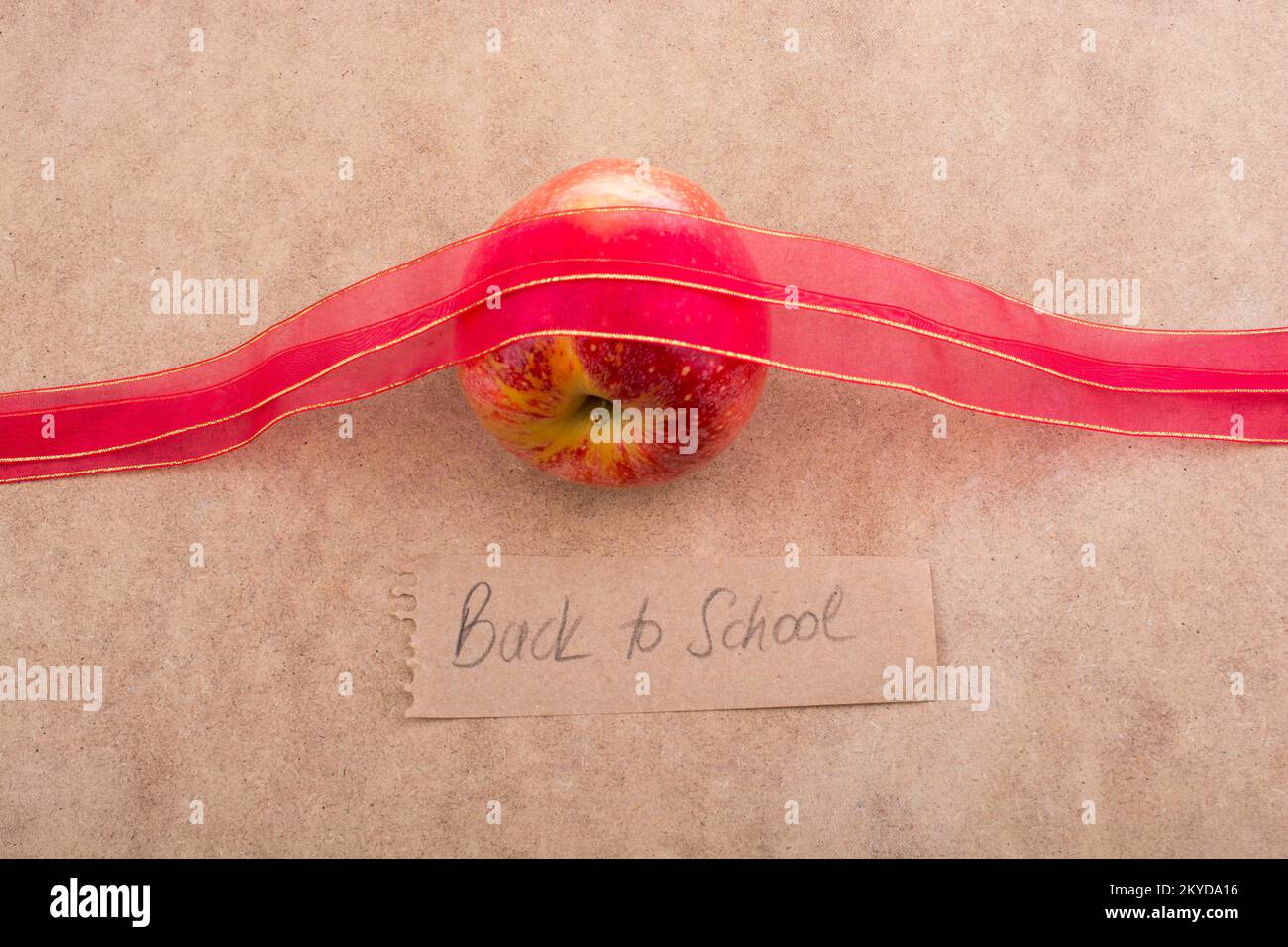 Back to school lettering with apple and a red ribbon Stock Photo - Alamy