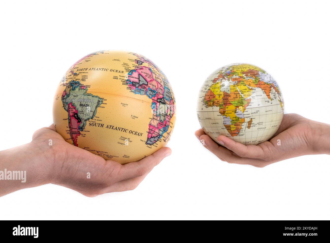 Two hands holding holding two globes in hand on white background Stock ...