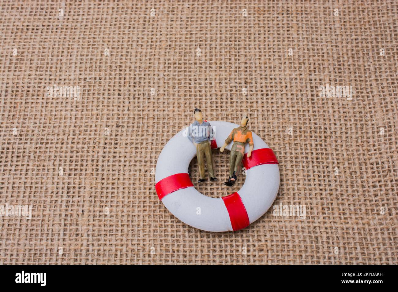 Little figurine men in a life preserver on life on canvas Stock Photo ...