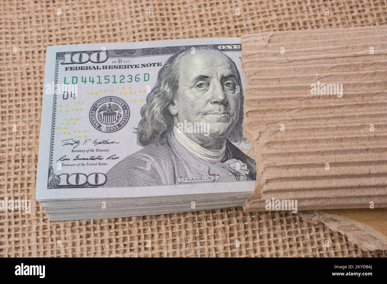 Banknote bundle of US dollar partly wrapped in cardboard Stock Photo ...