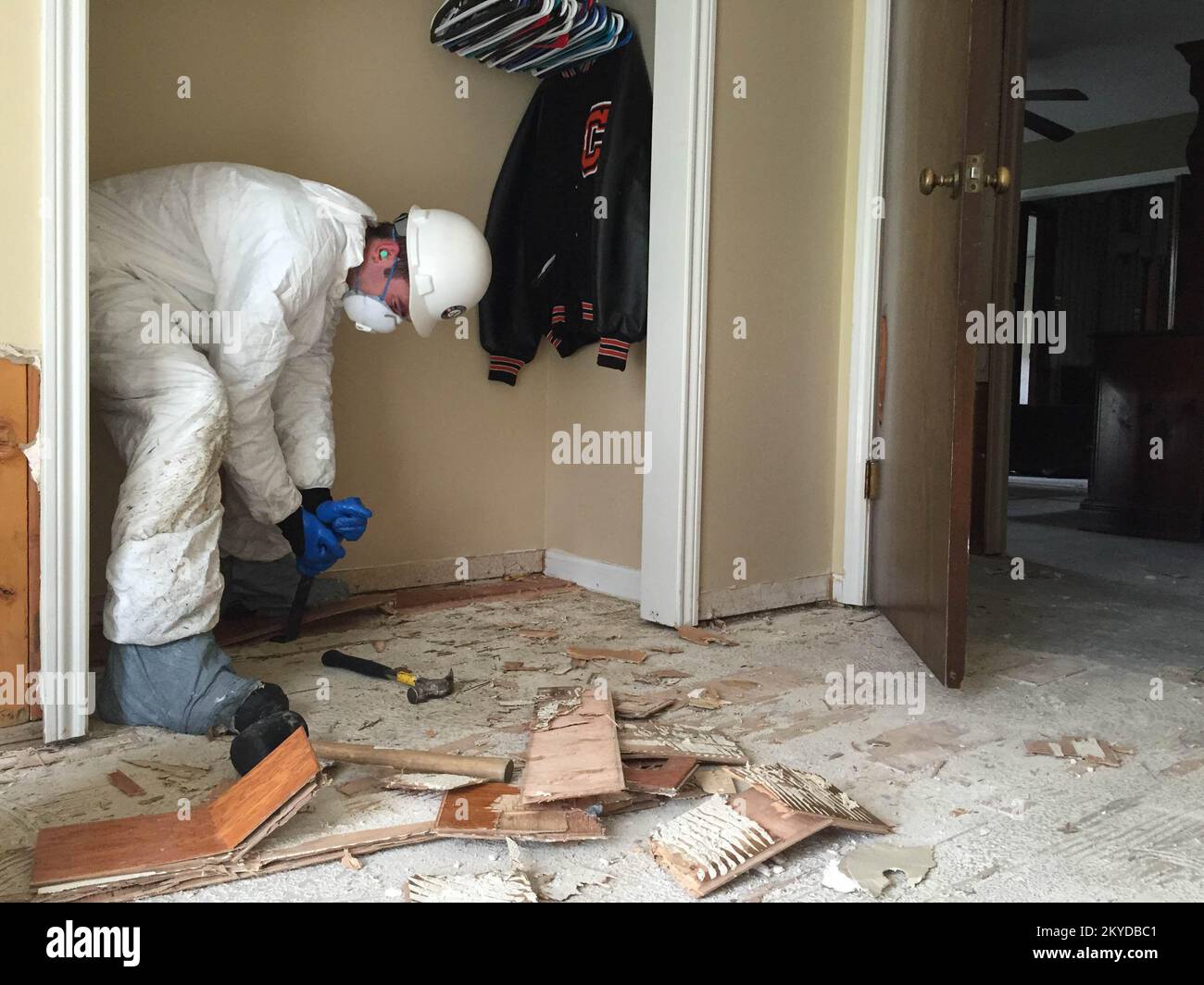 FEMA Corps member T.J Sullivan rips up the floorboards in the home of a ...